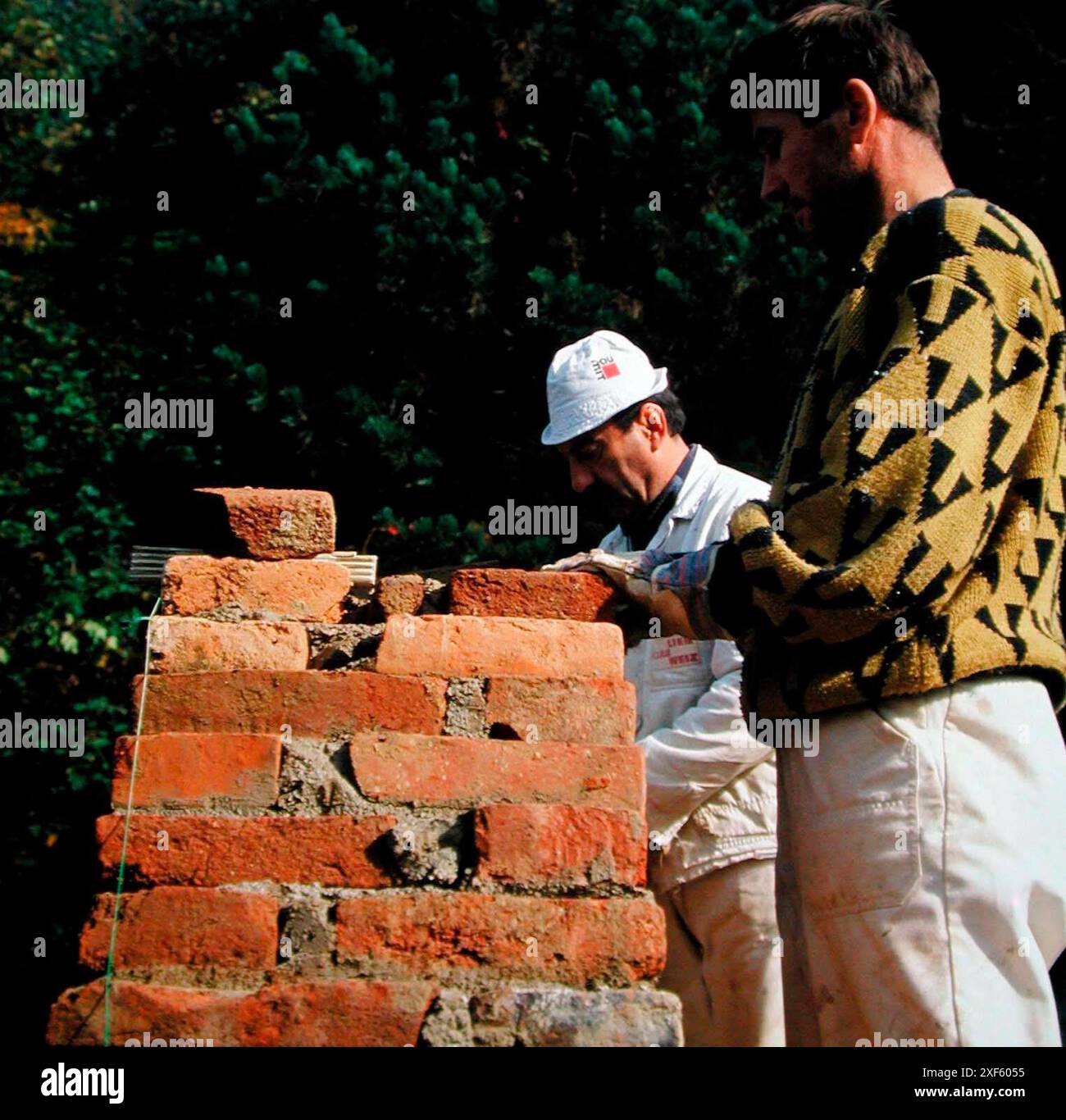 mason builds a brick wall, building work on a construction site mason ...