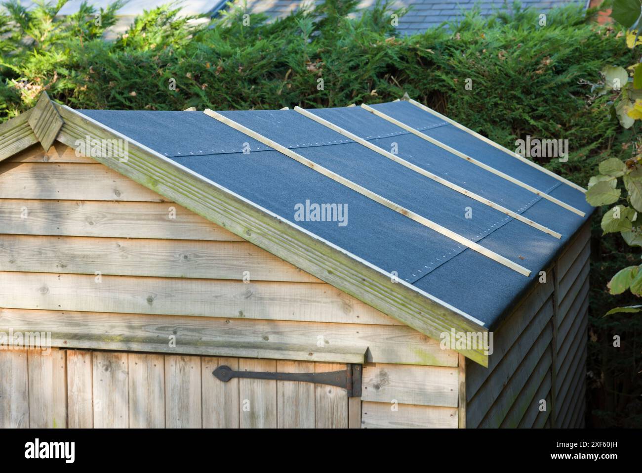 Wooden garden shed with new replacement felt roof. Part of a series ...