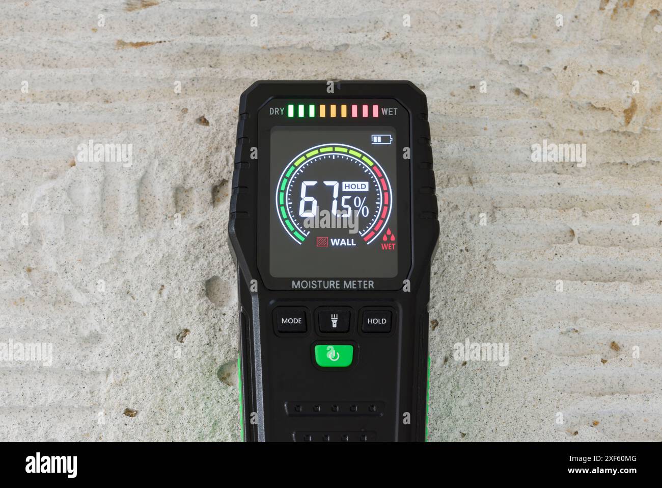 Moisture detector (moisture testing meter) on a concrete floor, reading ...
