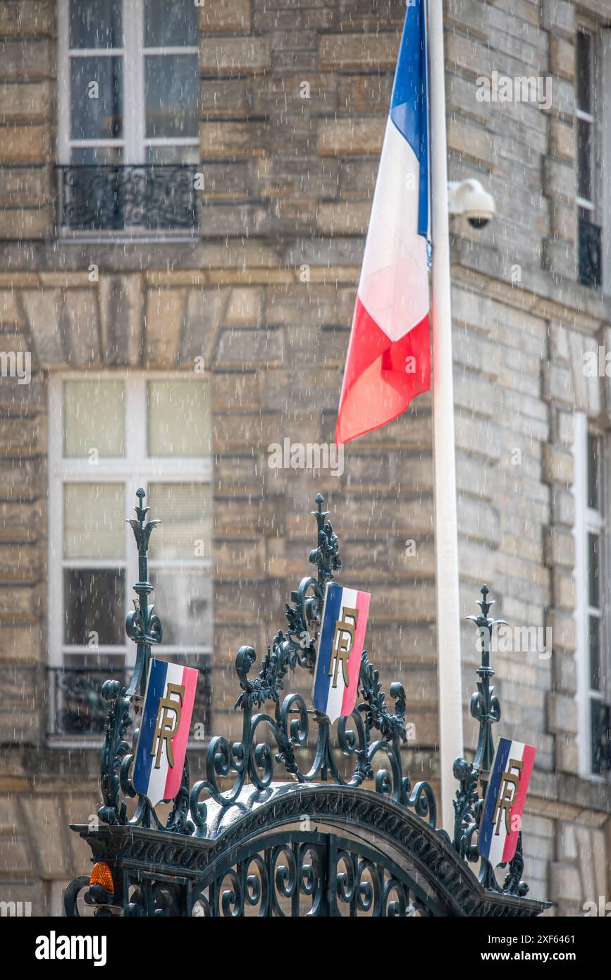 French flag waving in front of a historical building's ornate gate in ...