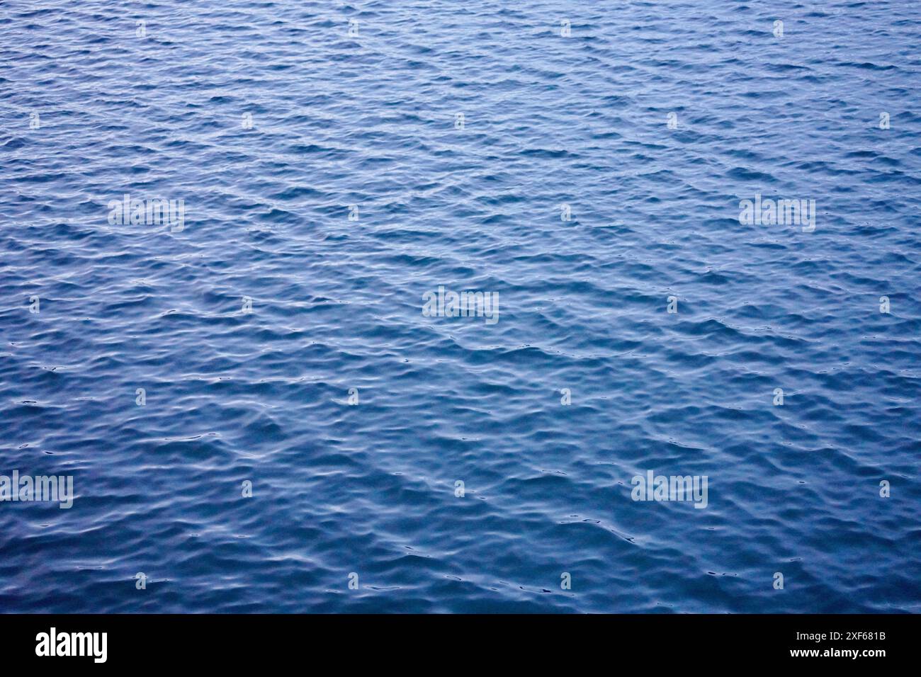 A serene view of rippling blue water surface with gentle waves Stock ...