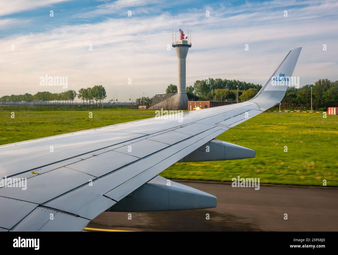 View from KLM aeroplane window of airplane landing on runway with ...