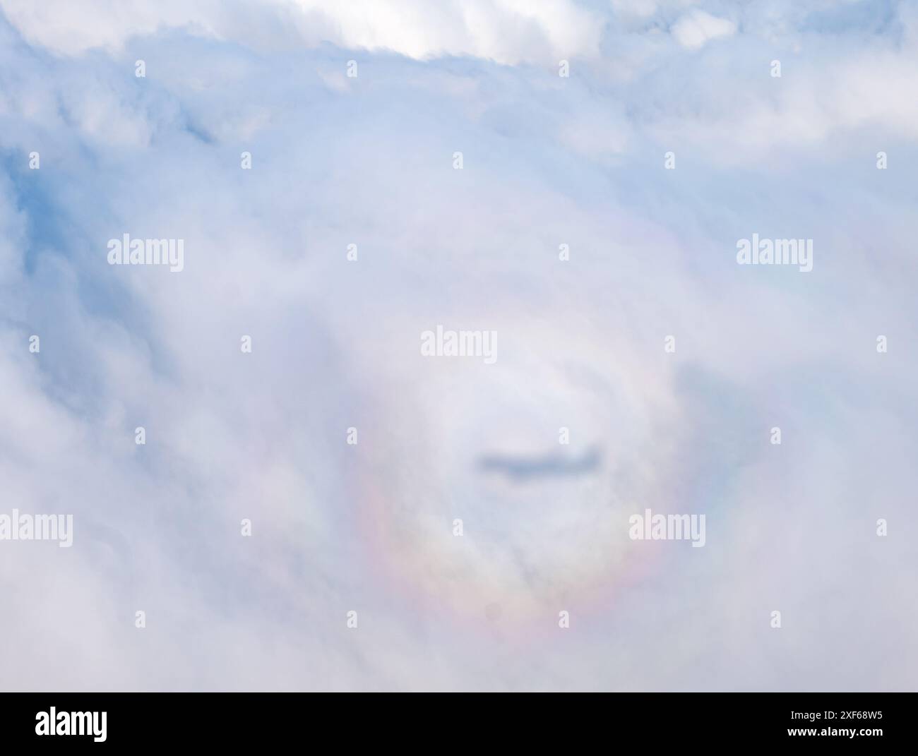 View from aeroplane window with optical illusion in clouds of ...