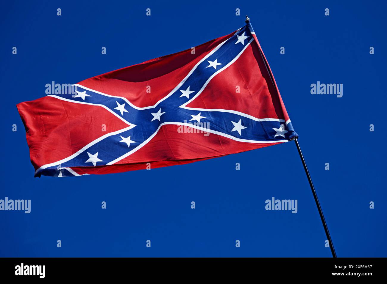 the american confederate flag against blue sky Stock Photo - Alamy