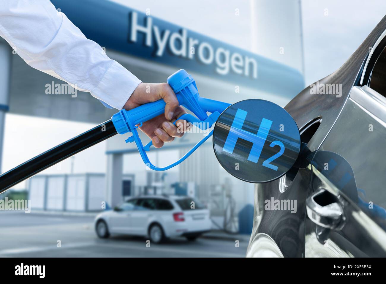 Man holds a hydrogen fueling nozzle. Refueling car with hydrogen fuel ...