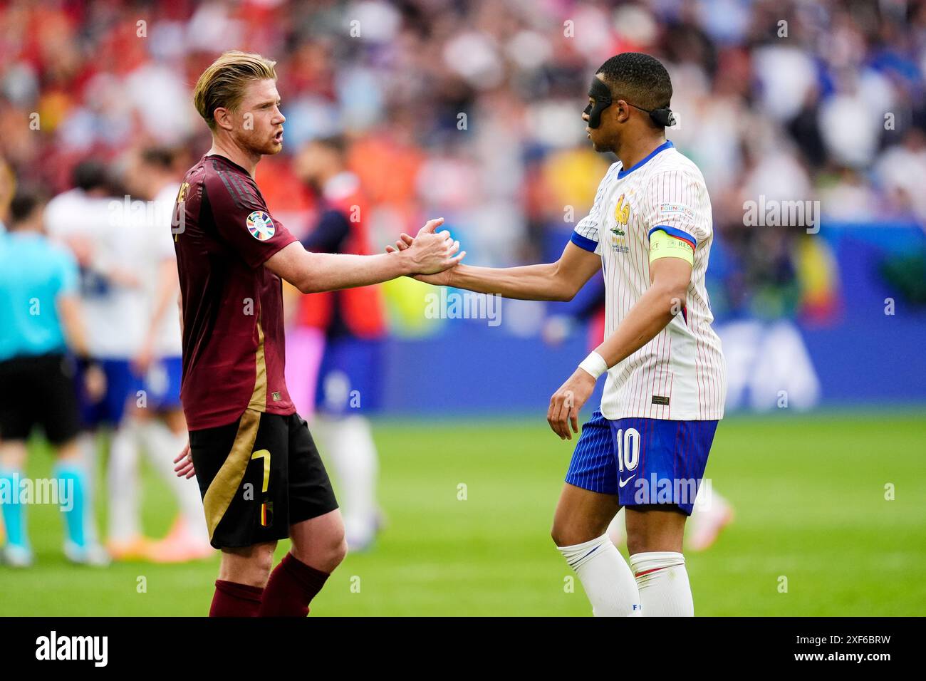 Belgium's Kevin De Bruyne (left) and France's Kylian Mbappe shake hands ...
