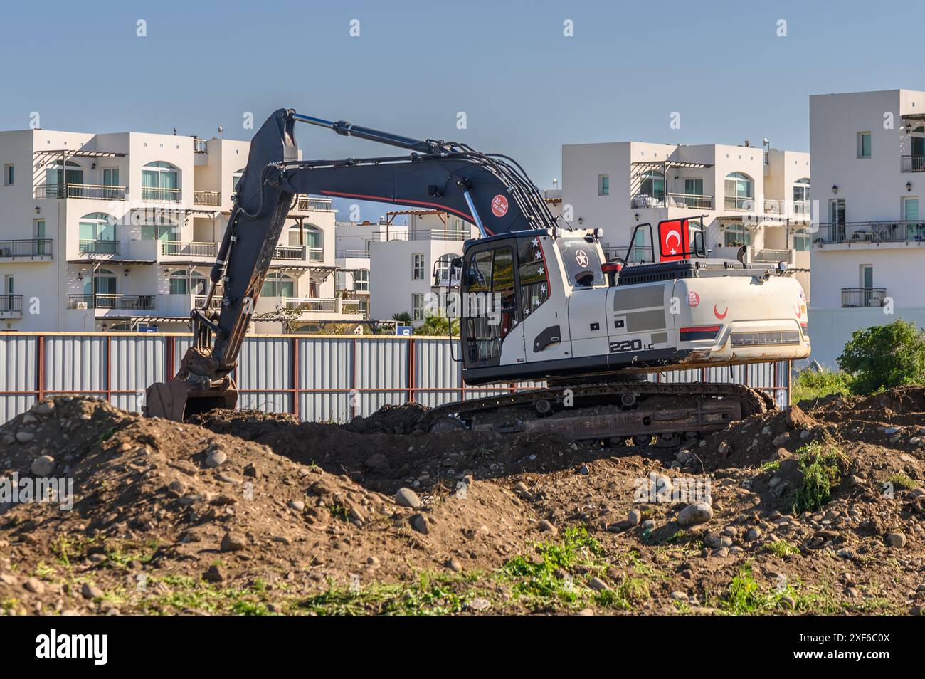Excavator digging soil at a construction site 2 Stock Photo - Alamy