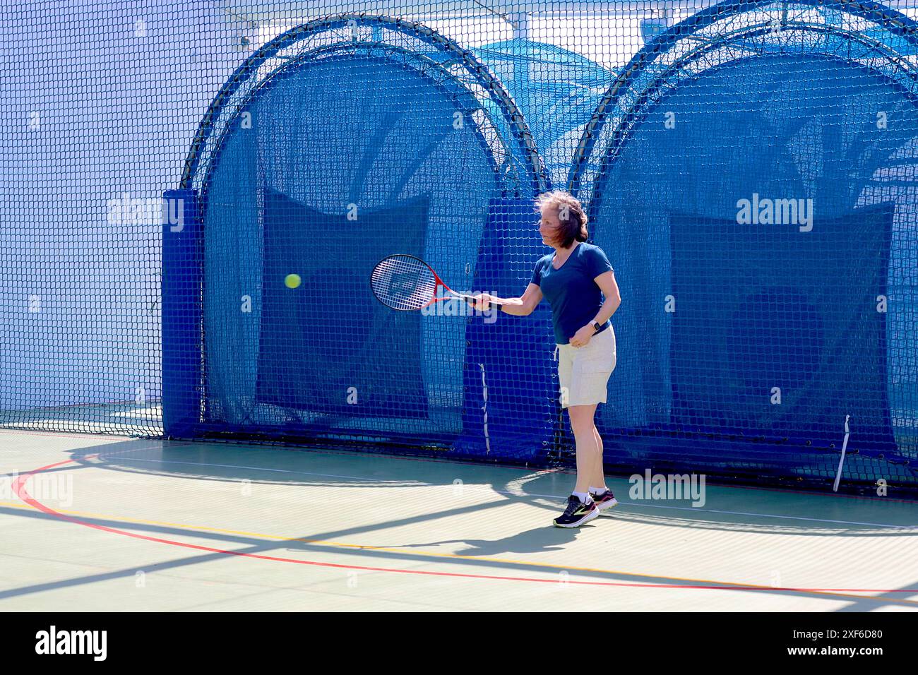 Netting covering the onboard games area on a cruise ship, as a female ...