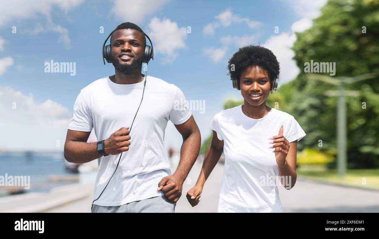 Woman jogging along river bank hi-res stock photography and images - Alamy