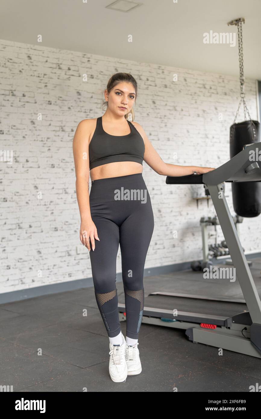 Portrait of a young blonde woman with her hair up and black clothes ...