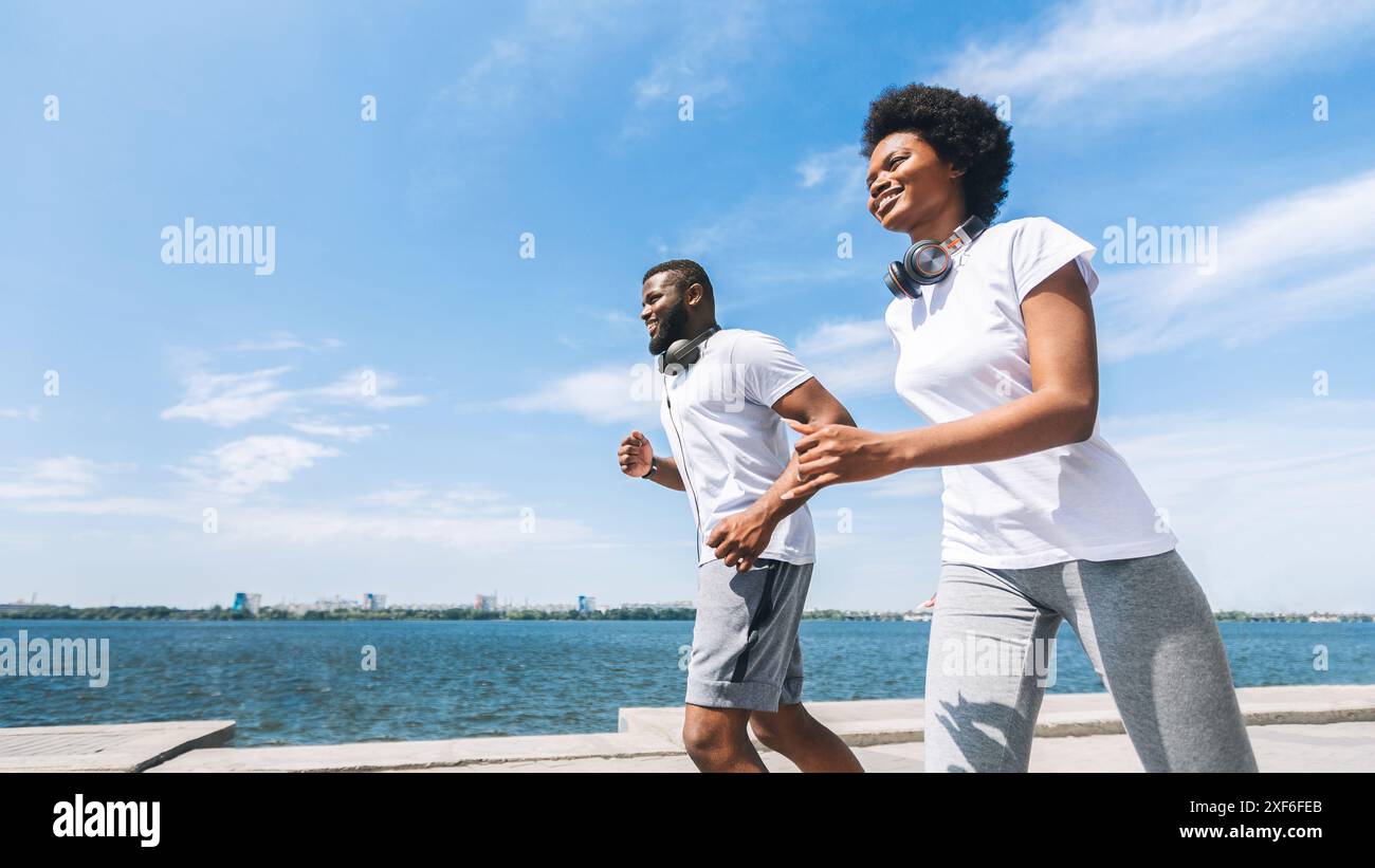 Woman jogging along river bank hi-res stock photography and images - Alamy