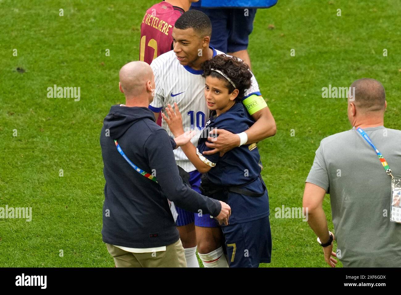 Kylian Mbappe of France puts his hand around the shoulders of a pitch ...