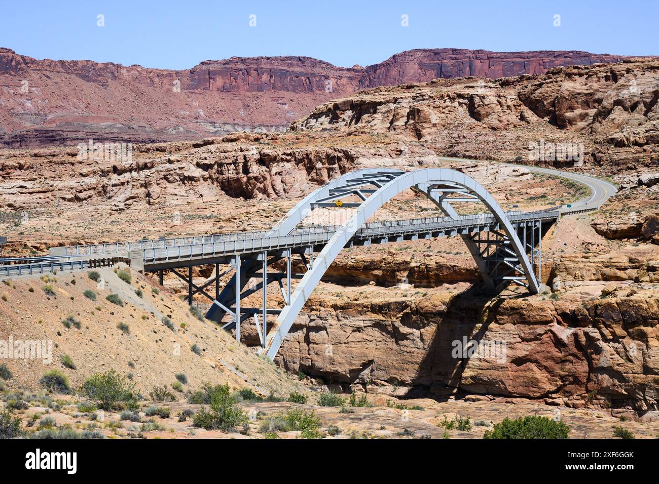 Arched Hite Crossing Bridge in canyon country of Utah with rocky desert ...