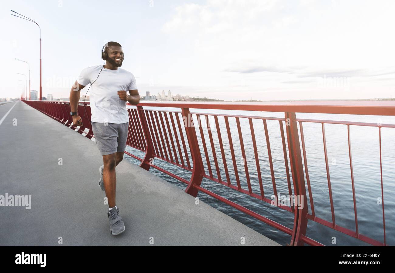 Man Running on Bridge With City Skyline Stock Photo - Alamy