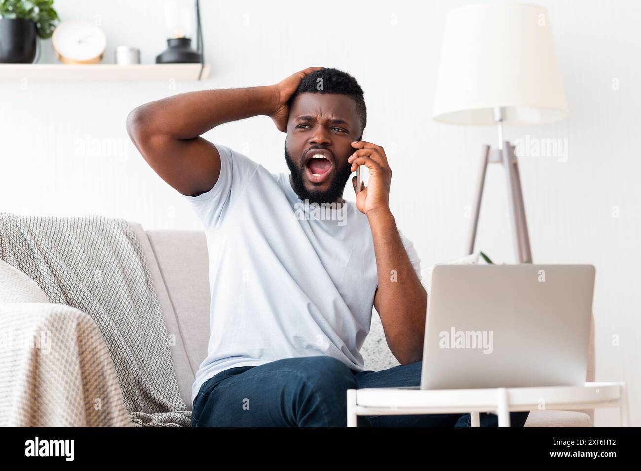 Shocked Man Receiving Bad News on Phone Call Stock Photo - Alamy