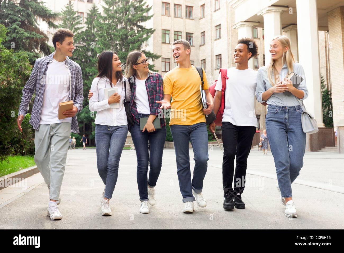 Free time of students, teens walking after passing test Stock Photo - Alamy