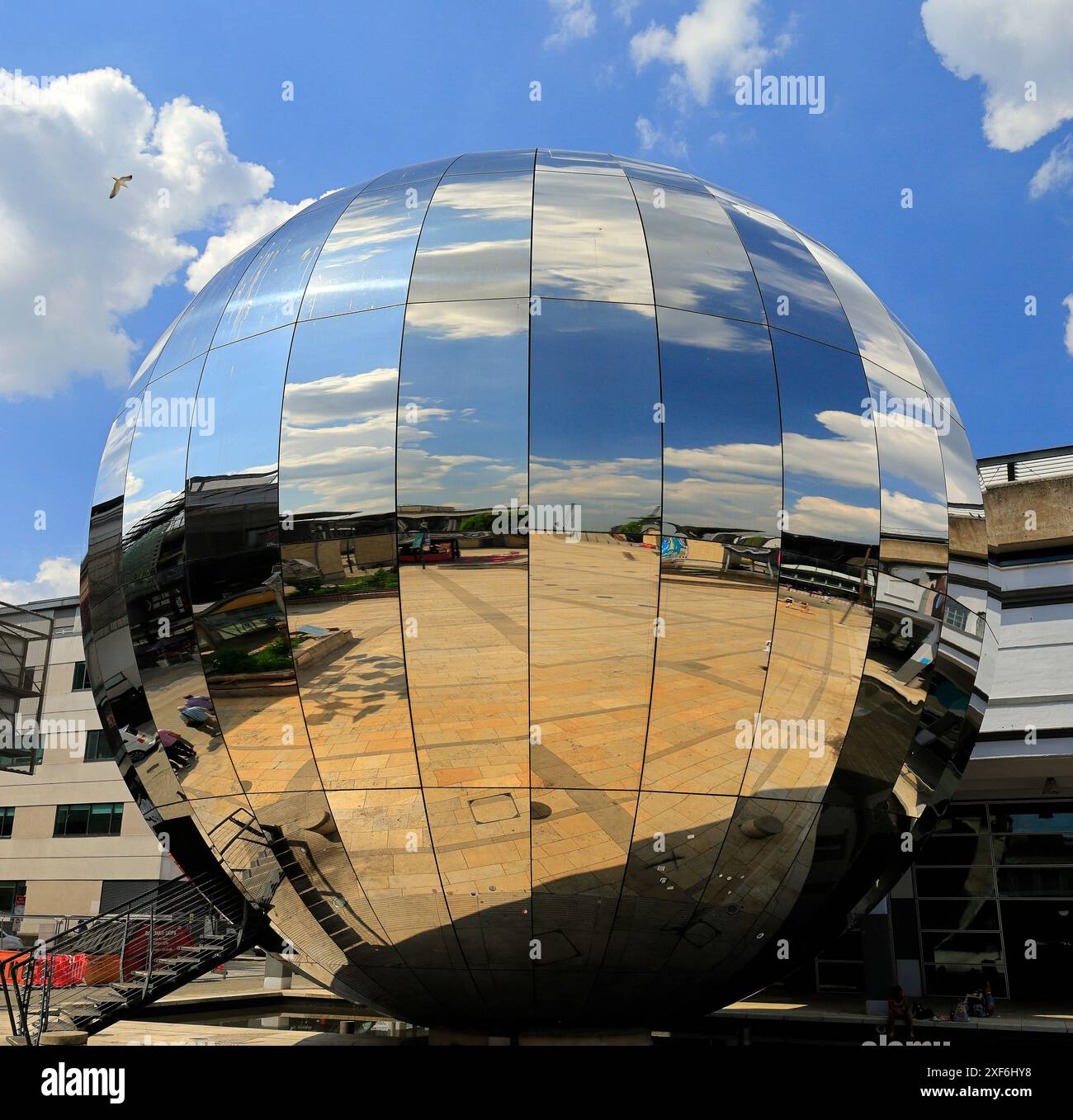The Millennium Sphere reflecting blue sky and fluffy clouds in ...
