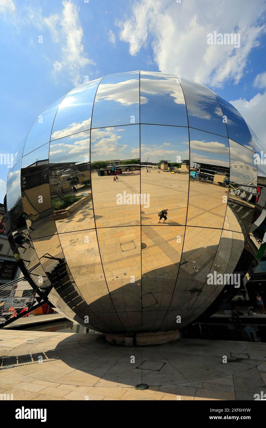 The Millennium Sphere reflecting blue sky and fluffy clouds in Millennium Square, Bristol city ...