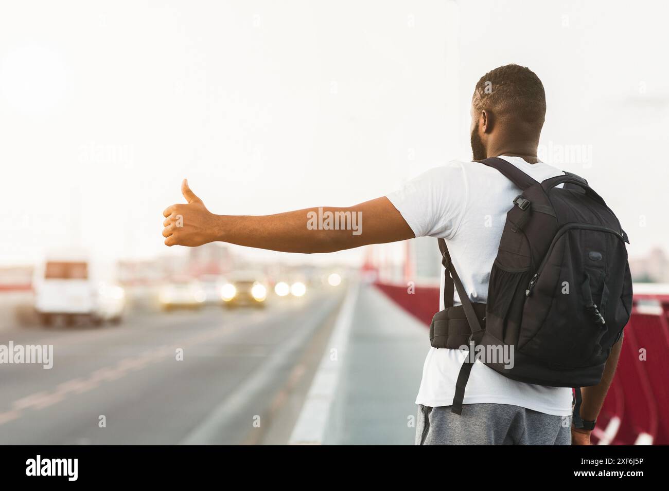 Man Hitchhiking on a Bridge Stock Photo - Alamy