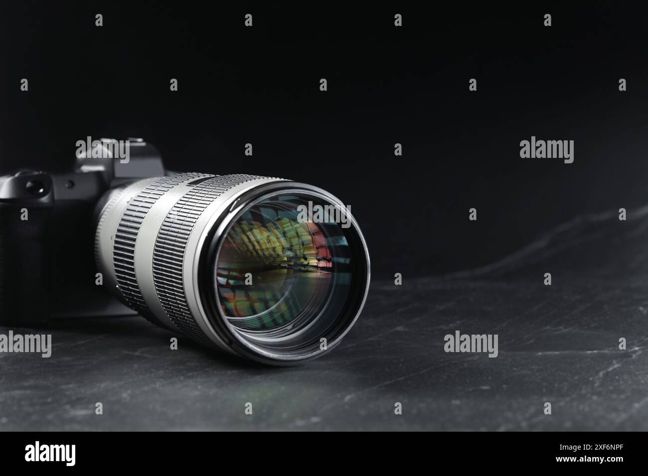 Modern photo camera on black table, space for text Stock Photo - Alamy