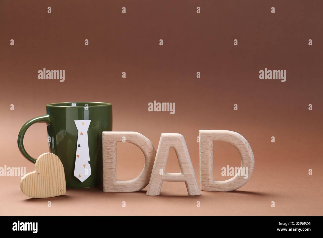 Happy Father's Day. Coffee in cup and word Dad made of wooden letters ...