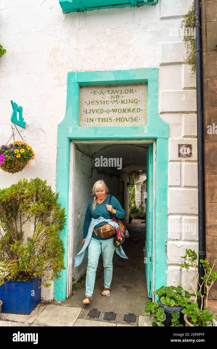 A woman emerging from The Greengate, High Street, former home of E.A ...