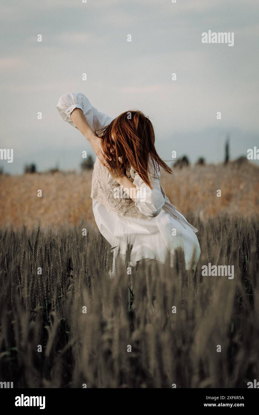 Young woman dancing outdoors. Modern dance performance in the meadow ...