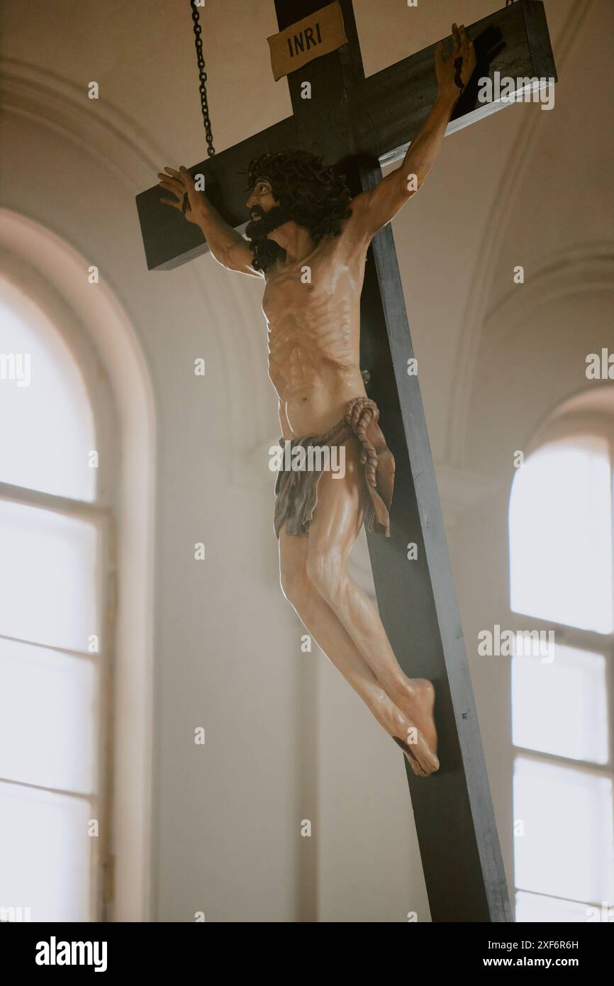 Vertical no people shot of sculpture of crucifixion of Jesus Christ in catholic church interior ...