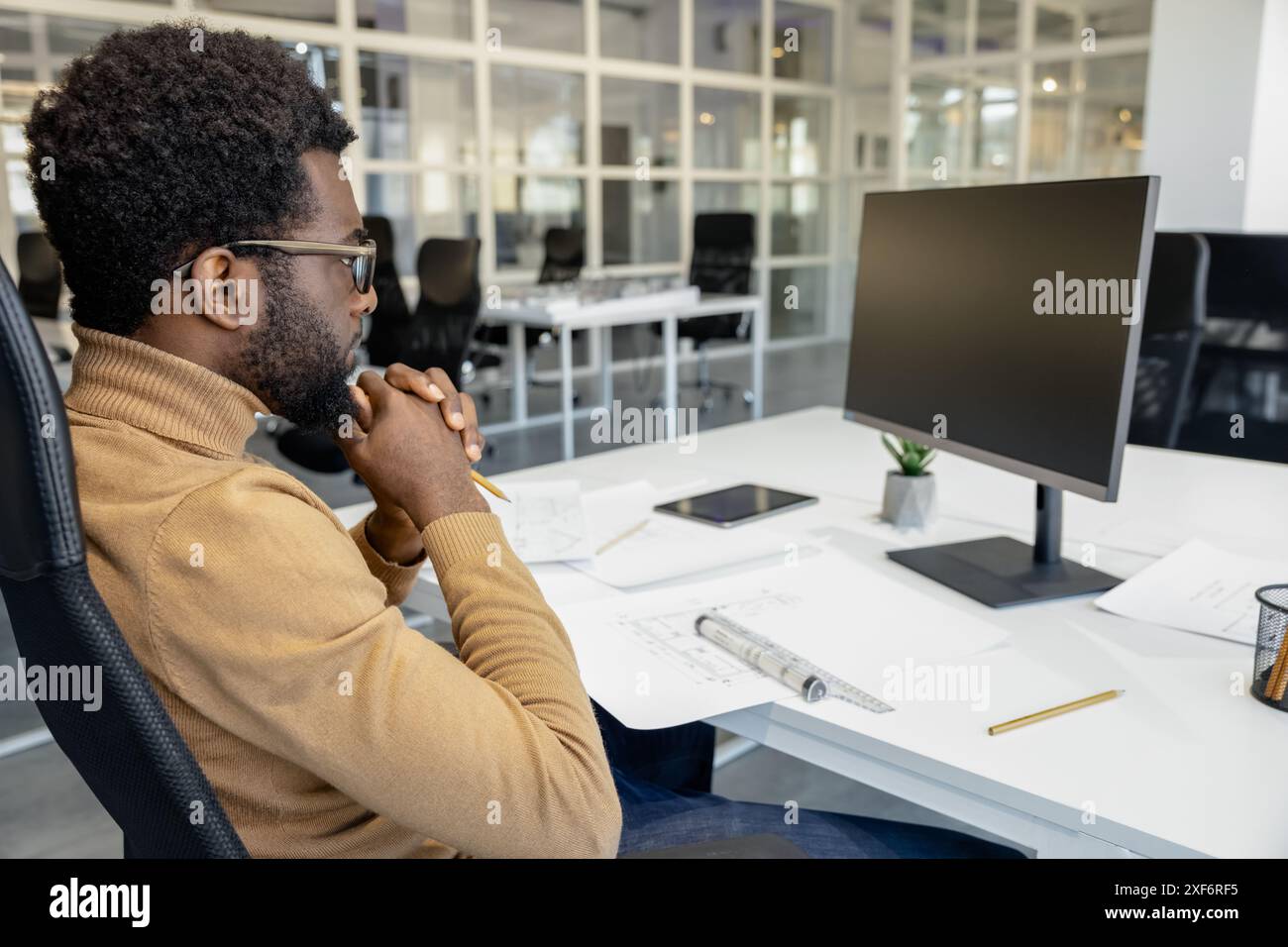 Skillful man architect creating blueprints for new projects on computer ...