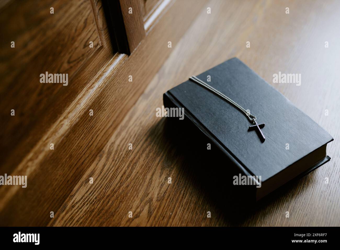High angle view closeup of Holy Bible book with silver cross on wooden ...