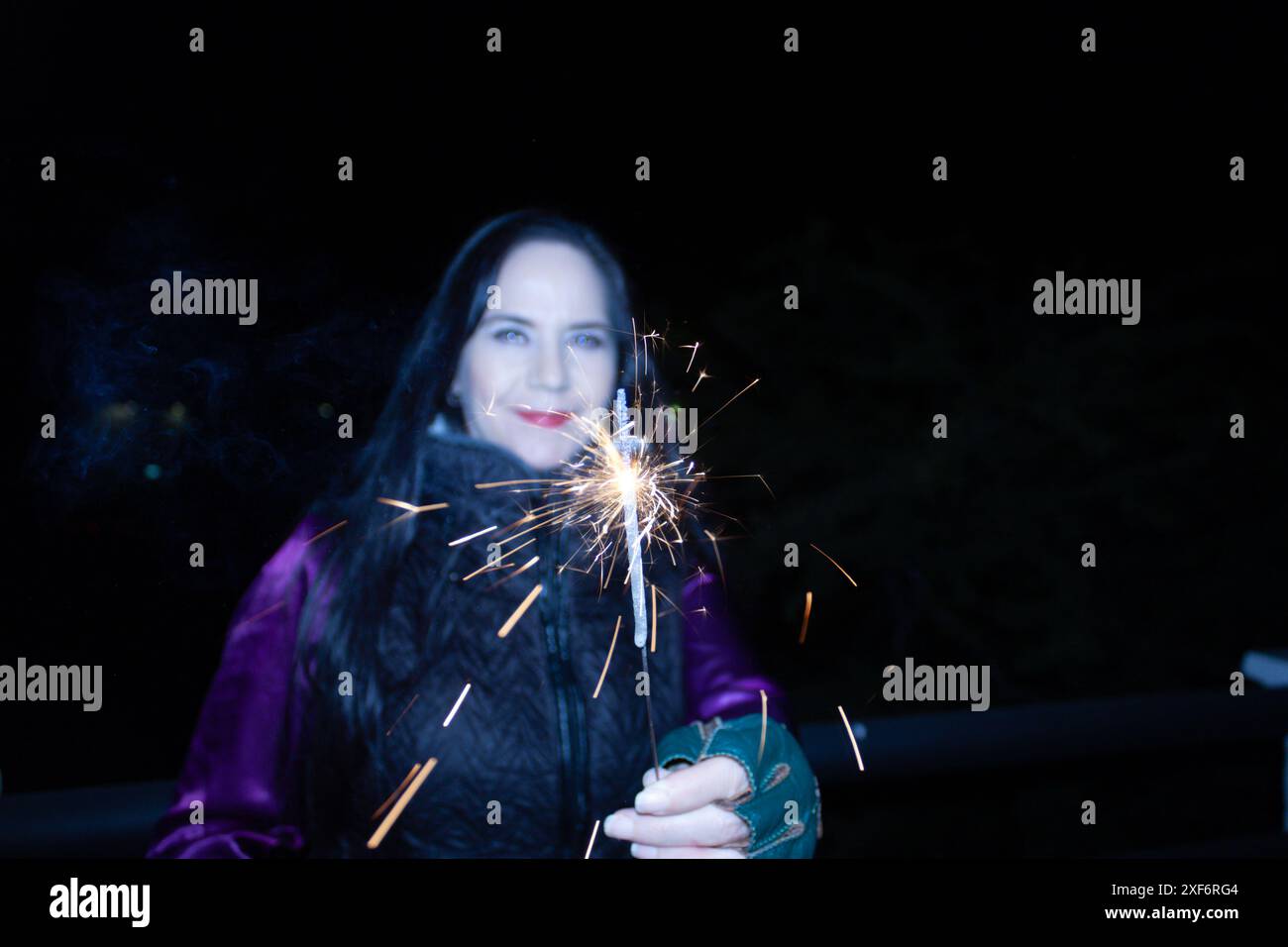Explosion of firework bengal light behind the sparks and smoke shows ...