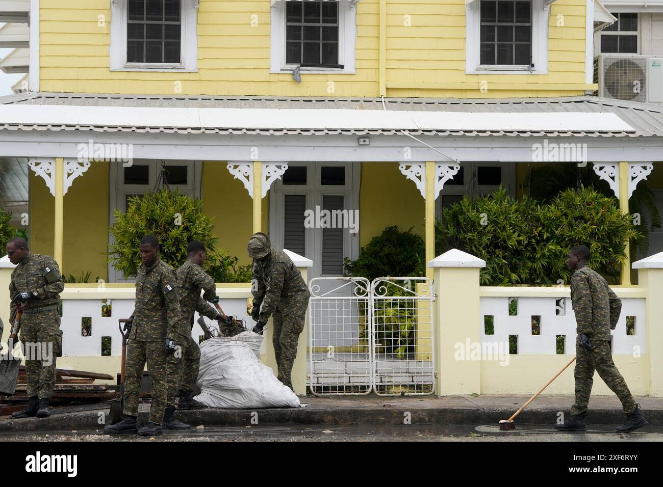 Members of the Barbados Defence Force clean up a street after Hurricane ...