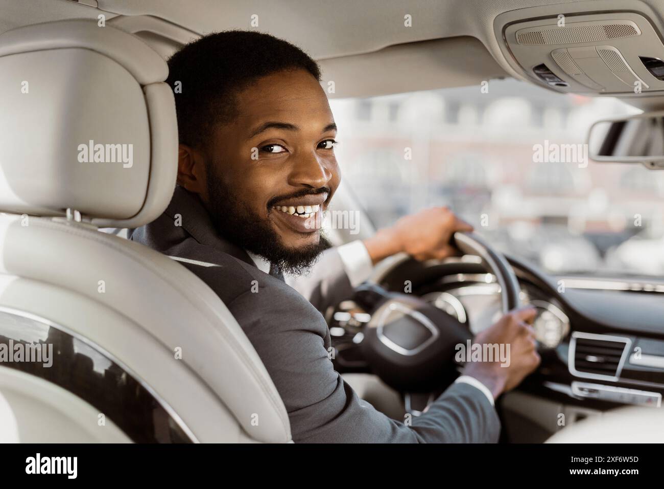 Happy African American Young Man Driving Car In Suit Stock Photo - Alamy