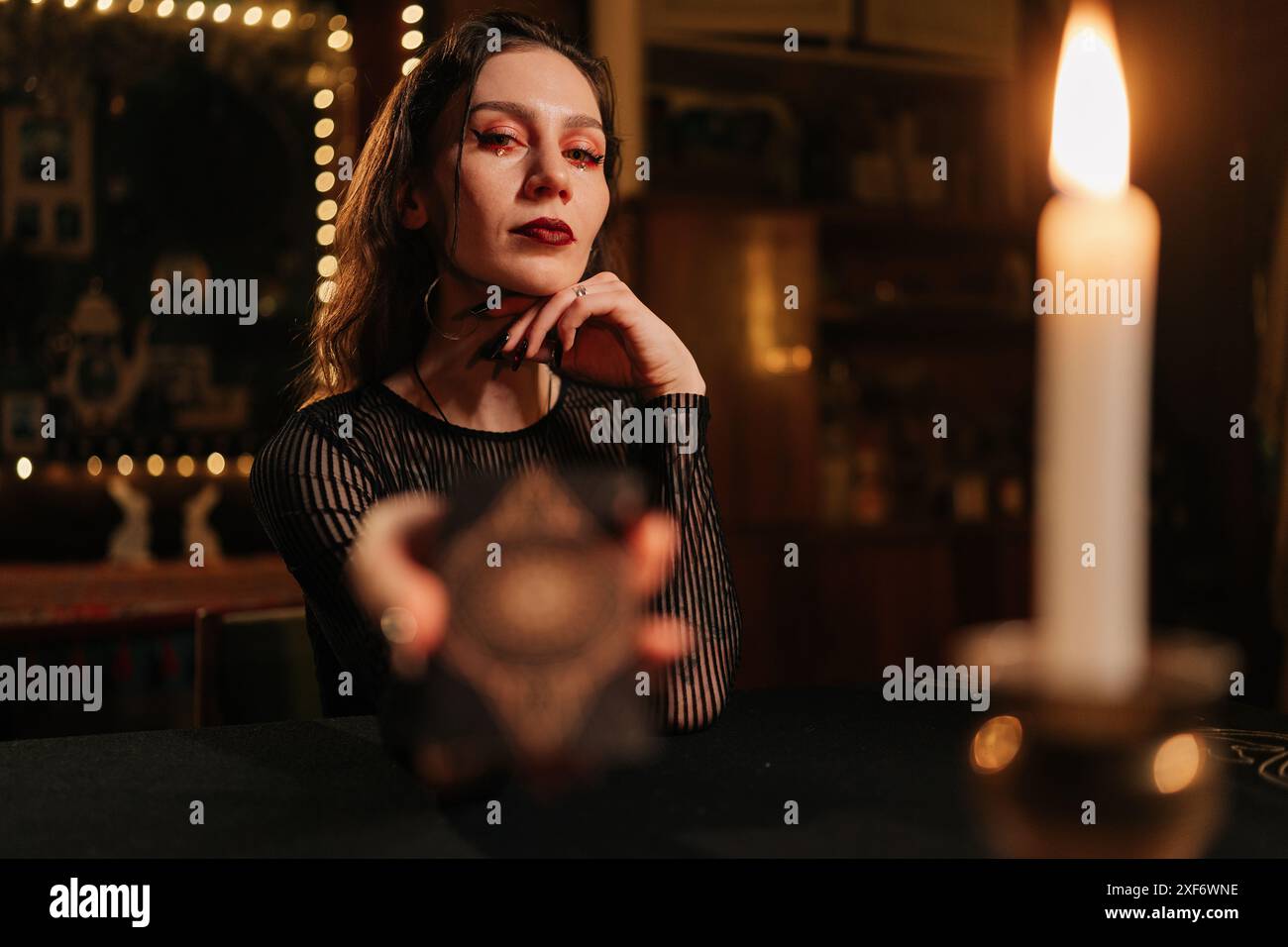 Portrait of mysterious fortune teller asking client to move deck of ...