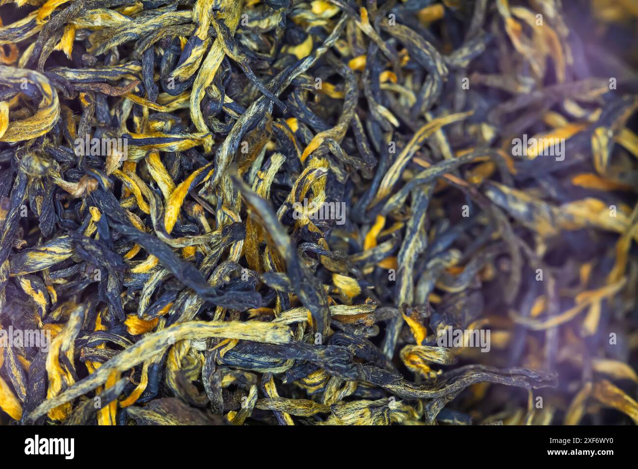 Close-up view of loose leaf black tea. The image captures the intricate ...