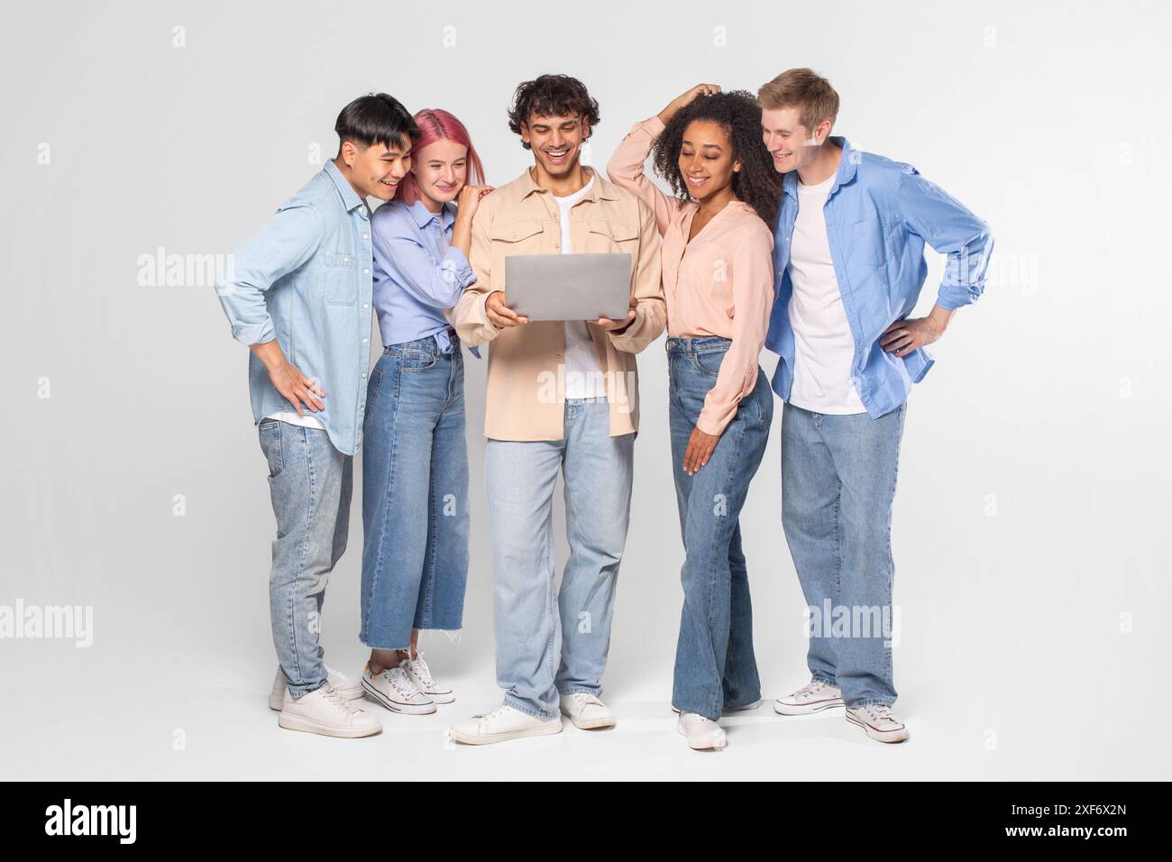 Diverse Group of Young Adults Looking at Laptop, White Background Stock ...