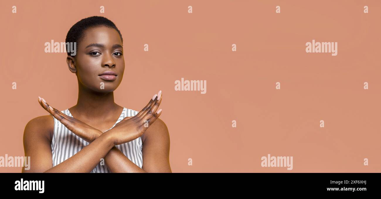 Woman Making A Stop Sign Gesture Against A Peach Background Stock Photo ...