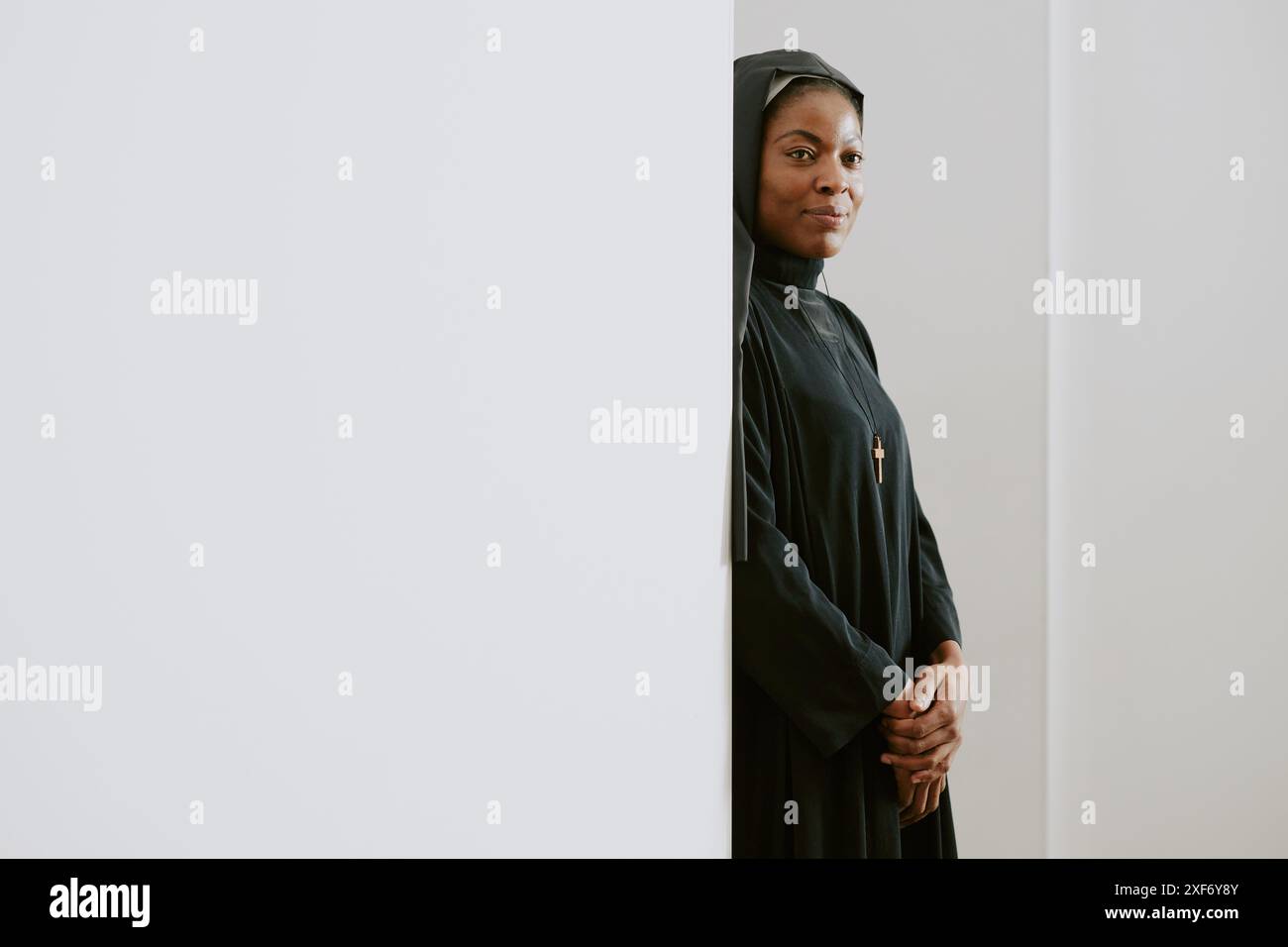 Minimalistic portrait of confident young African American Catholic nun ...