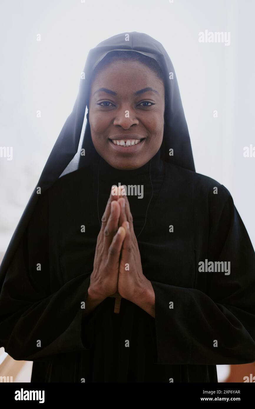 Vertical waist up portrait of happy African American Catholic nun ...