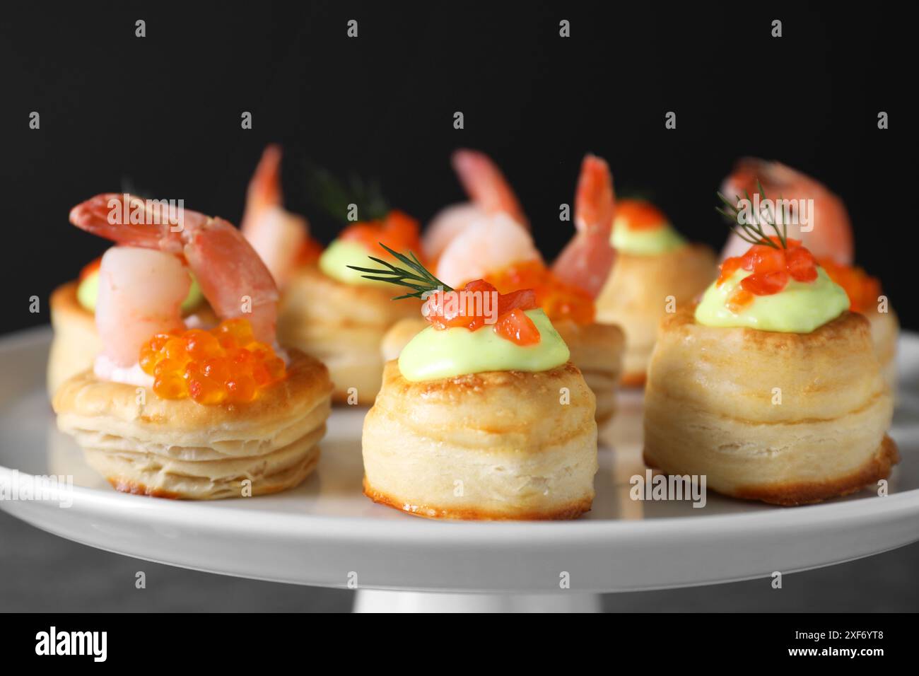 Different delicious puff pastry snacks on stand Stock Photo - Alamy
