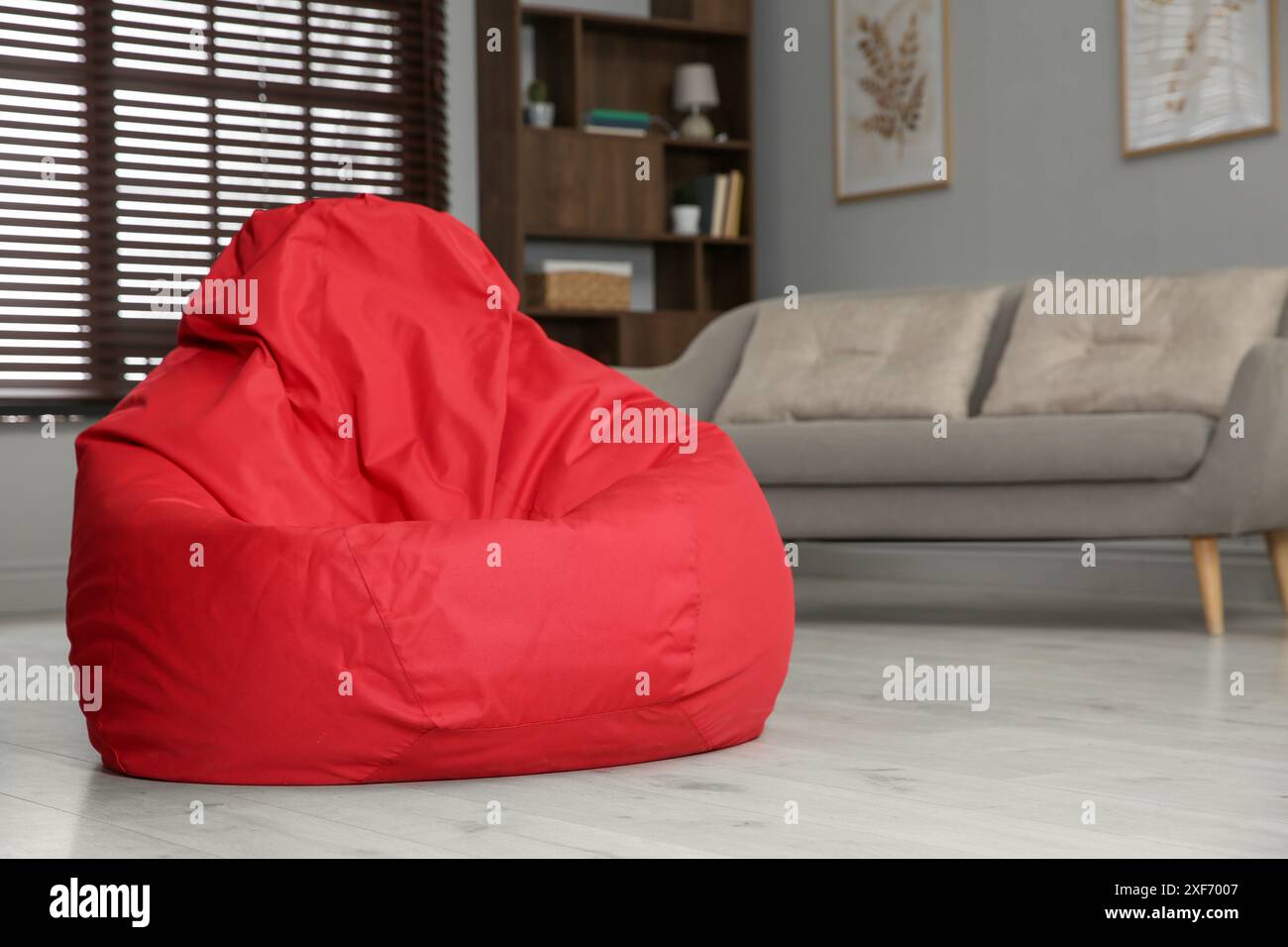 Red bean bag chair on floor in room Stock Photo - Alamy