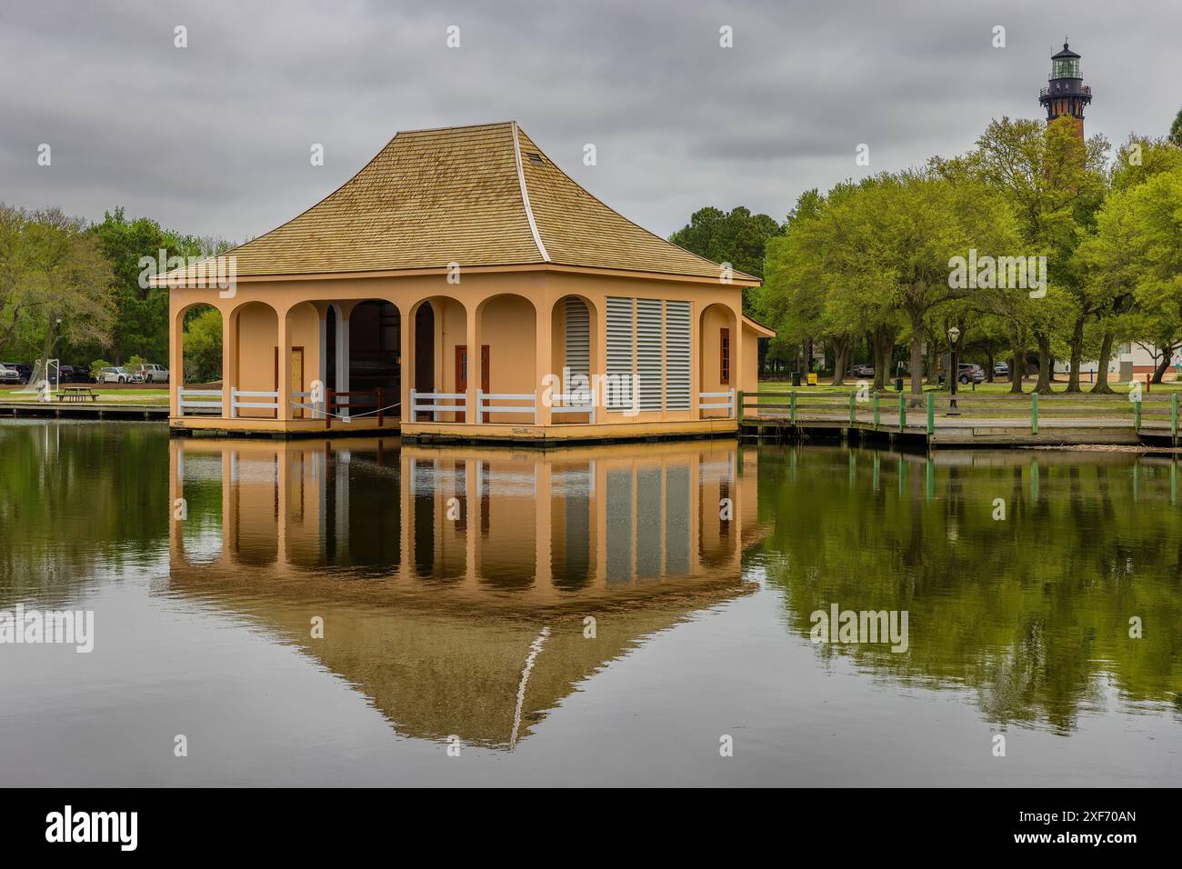 Boat house reflecting on inlet waters in historic Coralla Park with ...