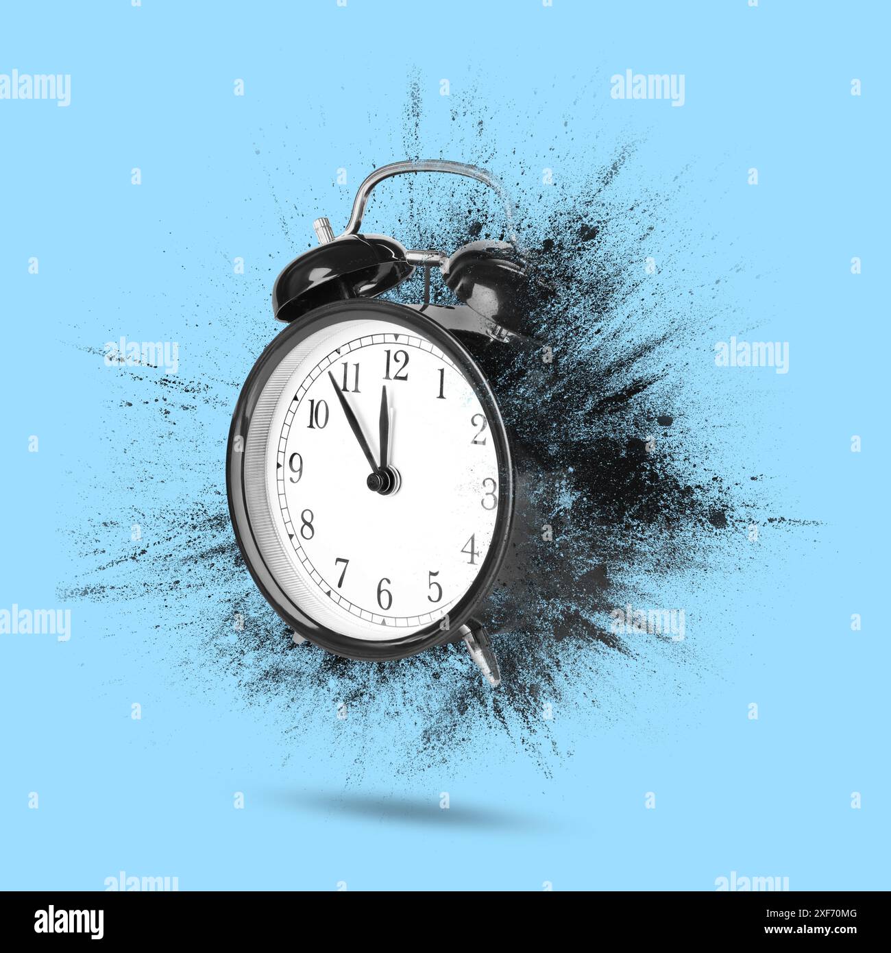 Black alarm clock dissolving on light blue background. Flow of time ...