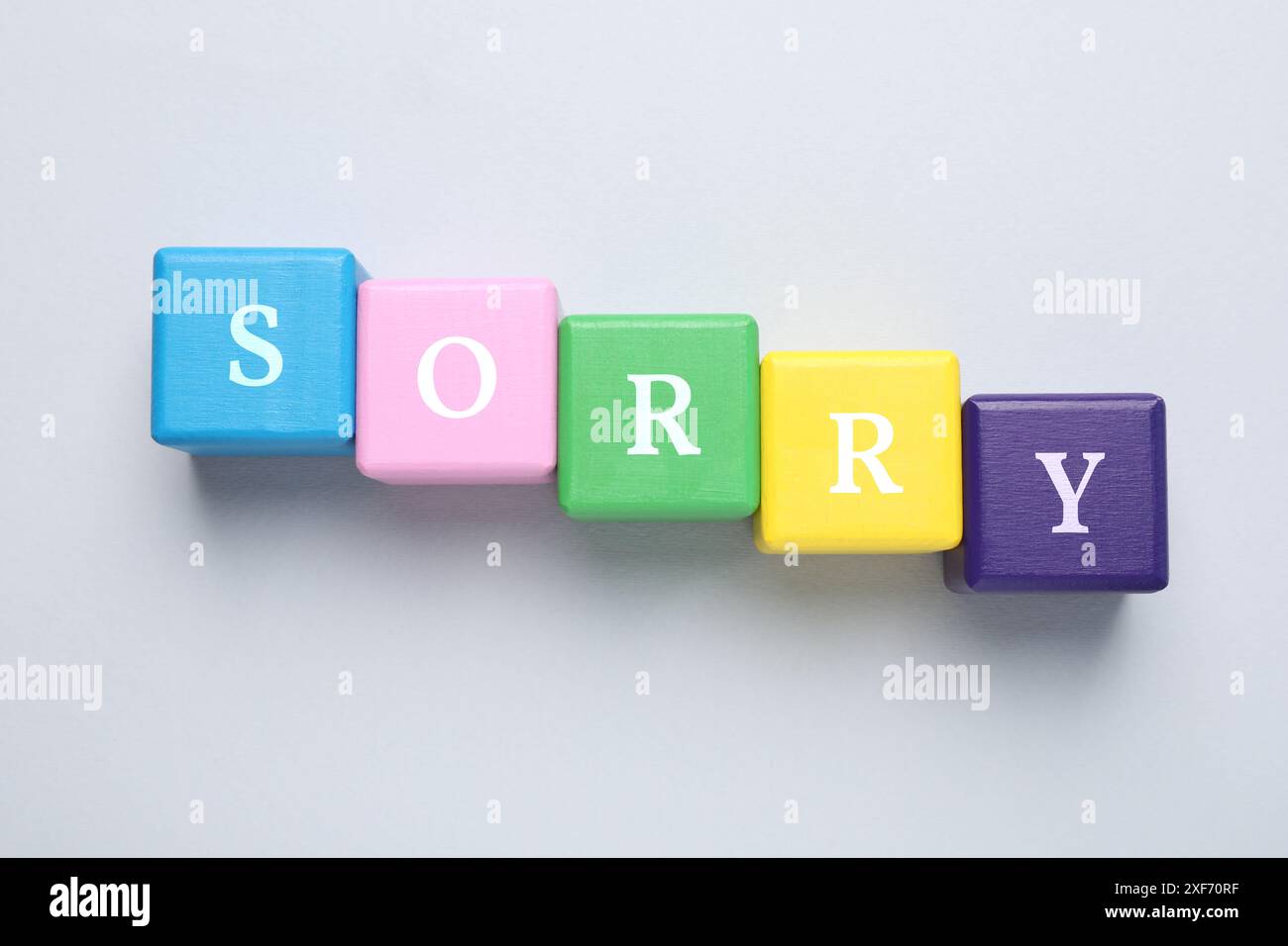 Word Sorry of colorful cubes with letters on light table, top view ...