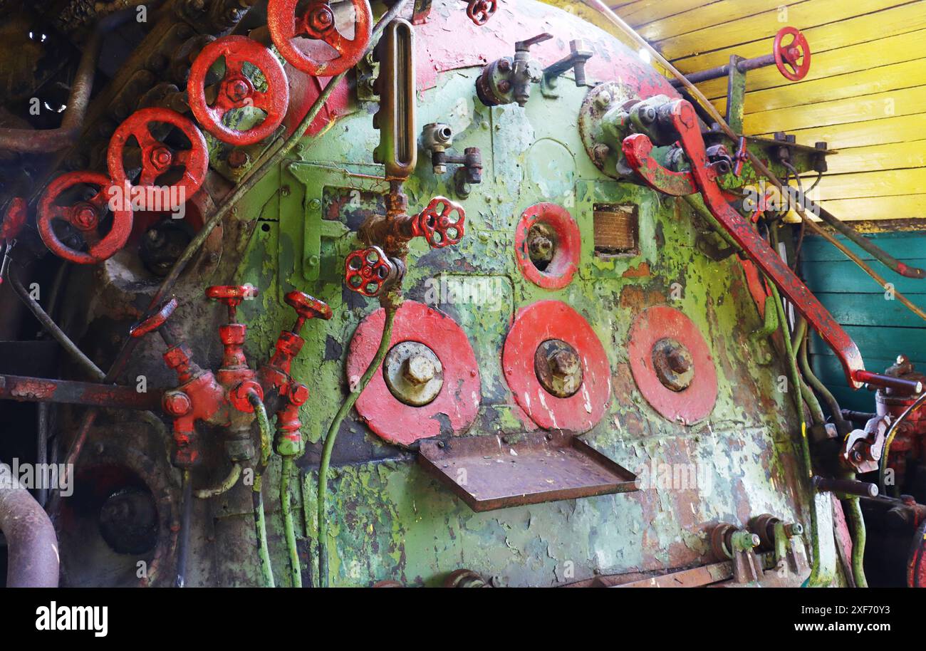 An old steam boiler with controls in the cabin of an abandoned, non ...
