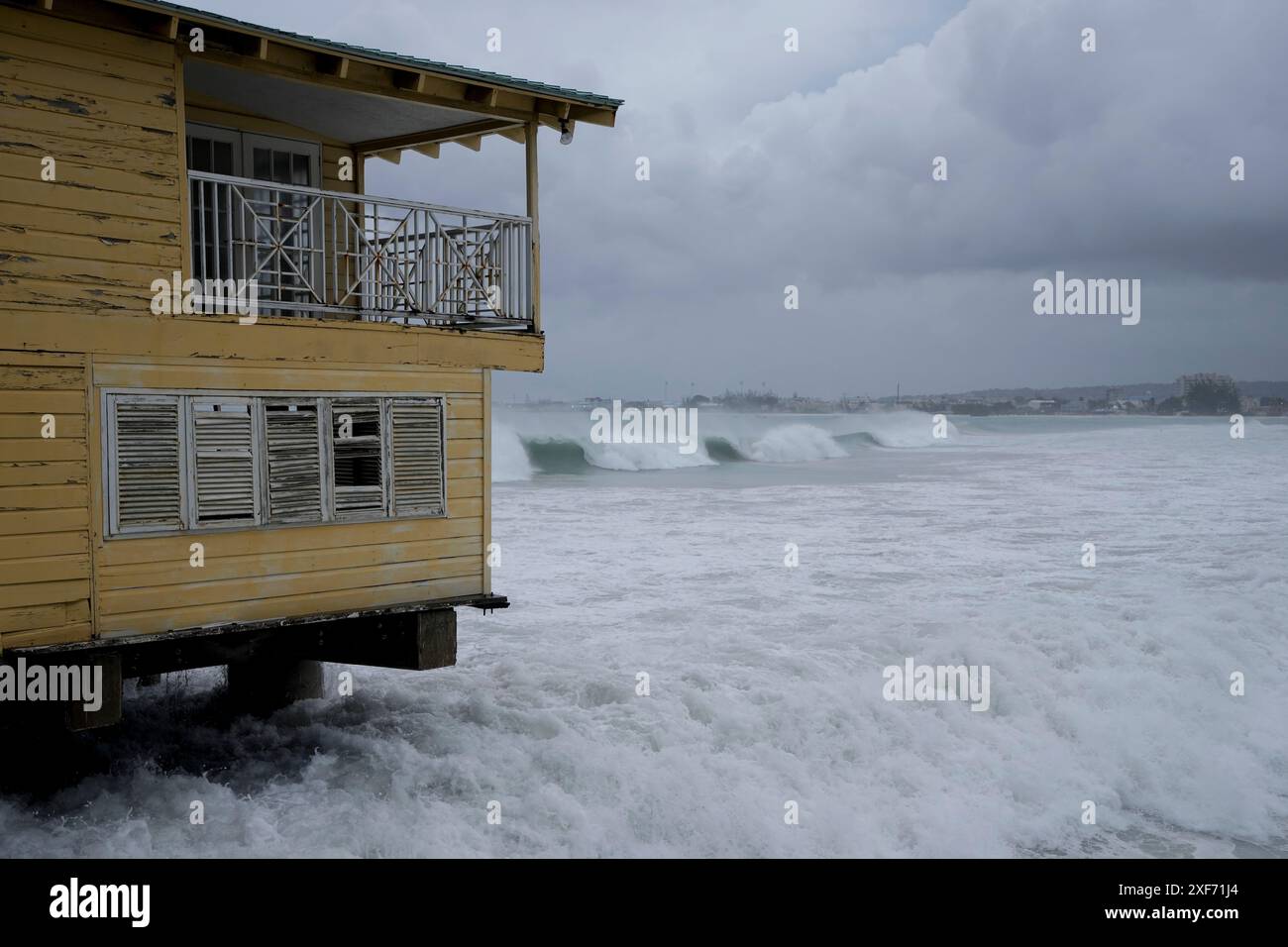 Waves batter a pier during the pass of Hurricane Beryl in Bridgetown ...