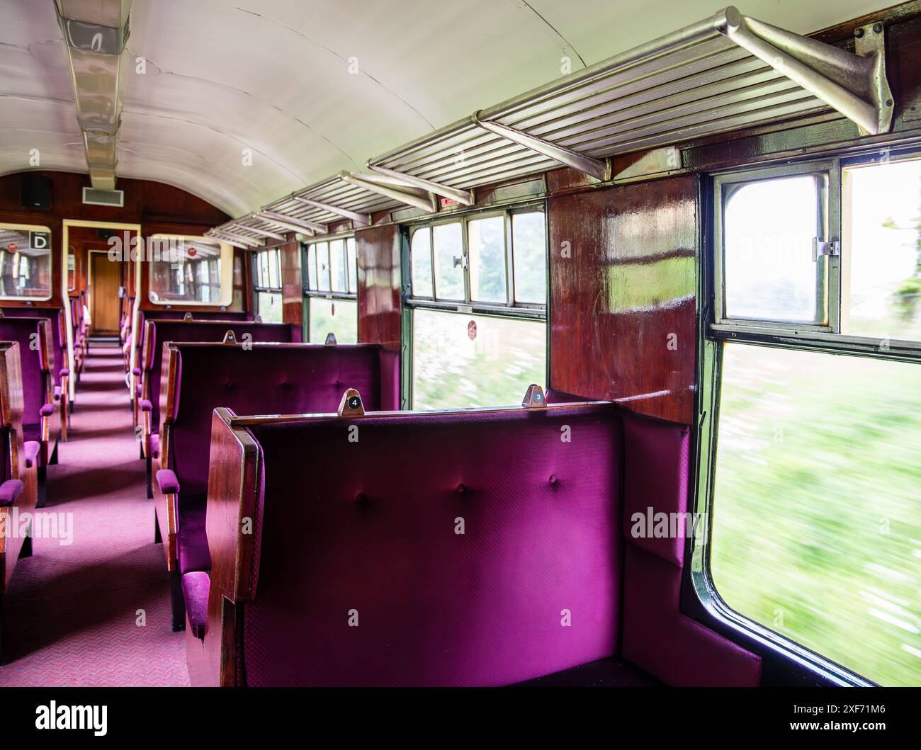 Interior of the Dartmouth steam train vintage carriage with empty red ...