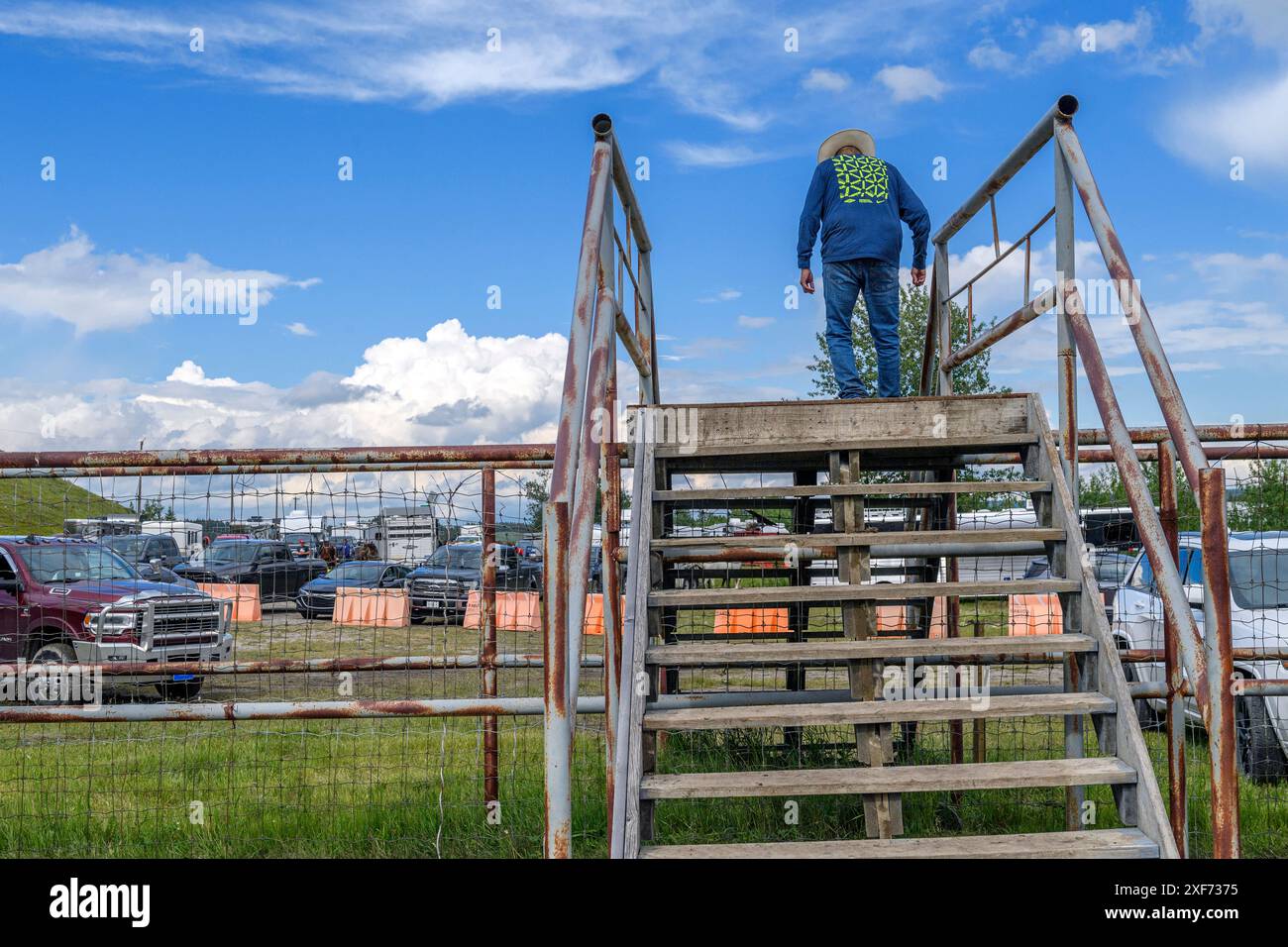 Indian cowboy crossing over cattle chutes at the Mini Thni Indian Rodeo ...