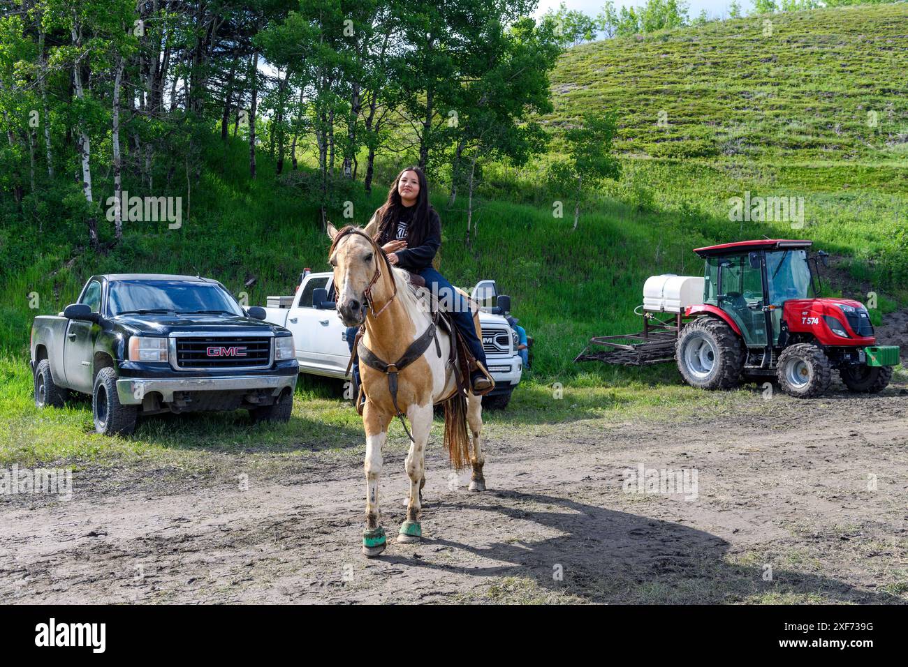 Young native girl riding a horse at the Mini Thni Indian Rodeo Chiniki ...