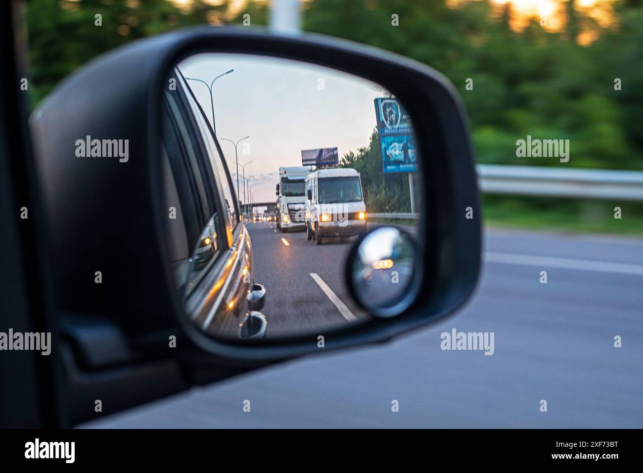 truck in the car's right side mirror while the car is driving in the ...